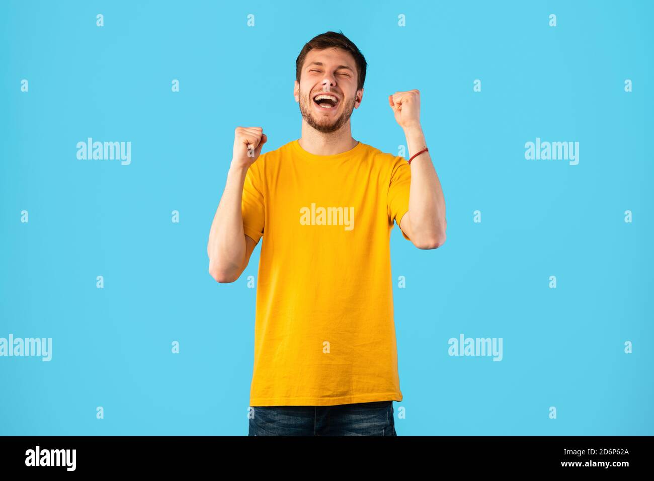 Portrait of happy guy screaming with raised fists Stock Photo - Alamy