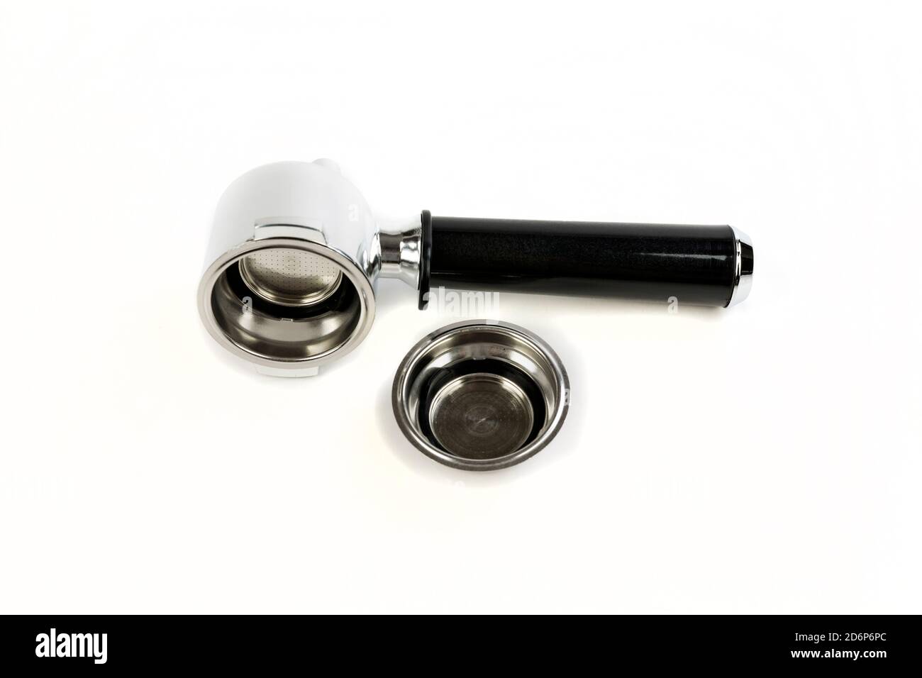 Black and silver coffee filter holder on its side with filter close by ...