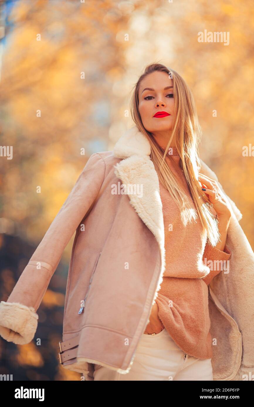 Beautiful woman in autumn park under fall foliage Stock Photo - Alamy