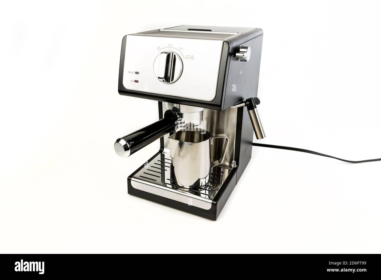 Espresso machine with filter in place and steaming cup below holder ...