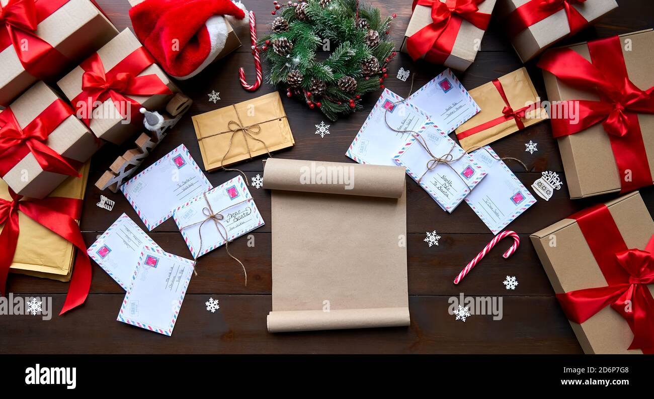 Merry Christmas decorated wooden table with wish list, gifts boxes, Top ...