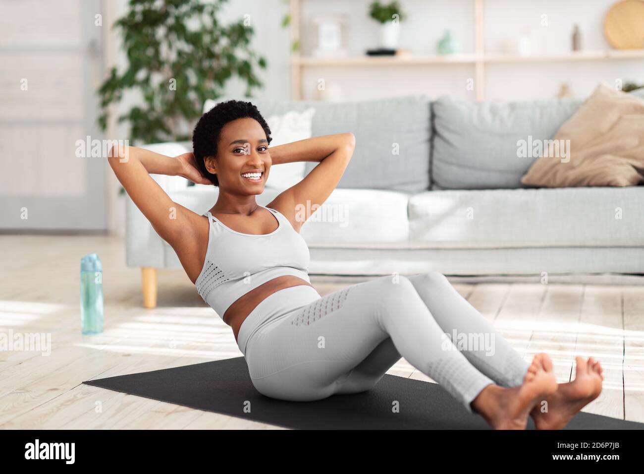 Full length portrait of beautiful African American woman keeping fit at ...