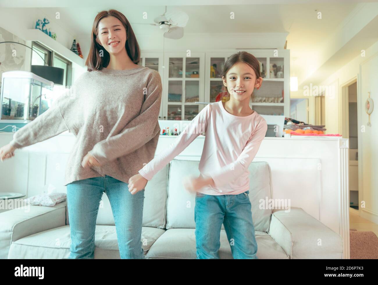 Happy mother and daughter dancing at home Stock Photo - Alamy