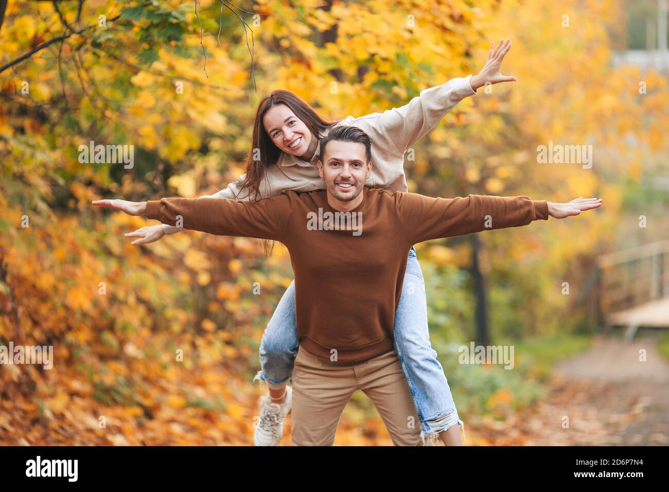 Happy family walking in autumn park on sunny fall day Stock Photo - Alamy