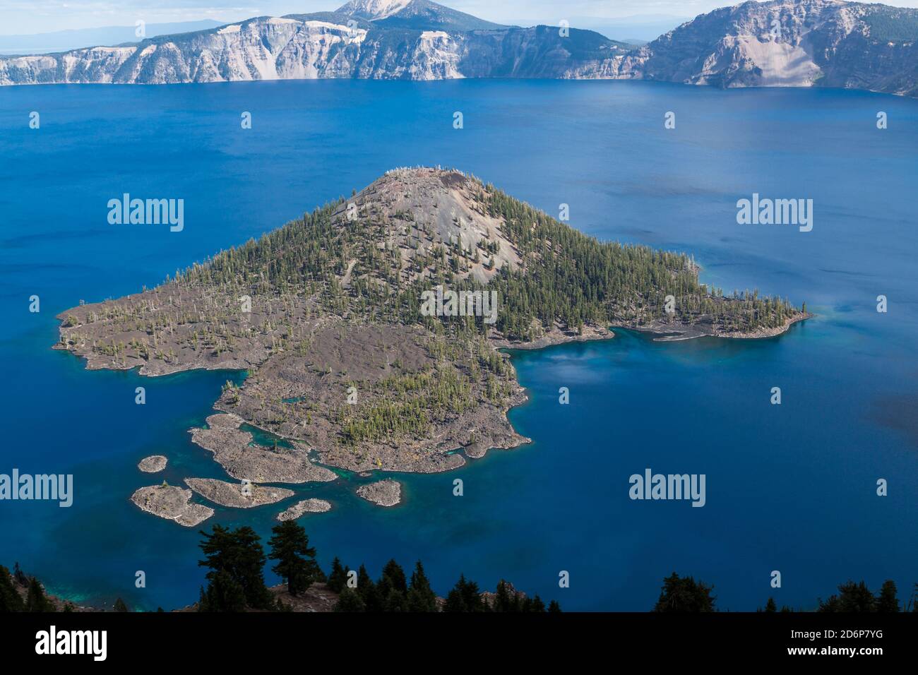 The volcanic cone of Wizard Island surrounded by the deep blue waters ...