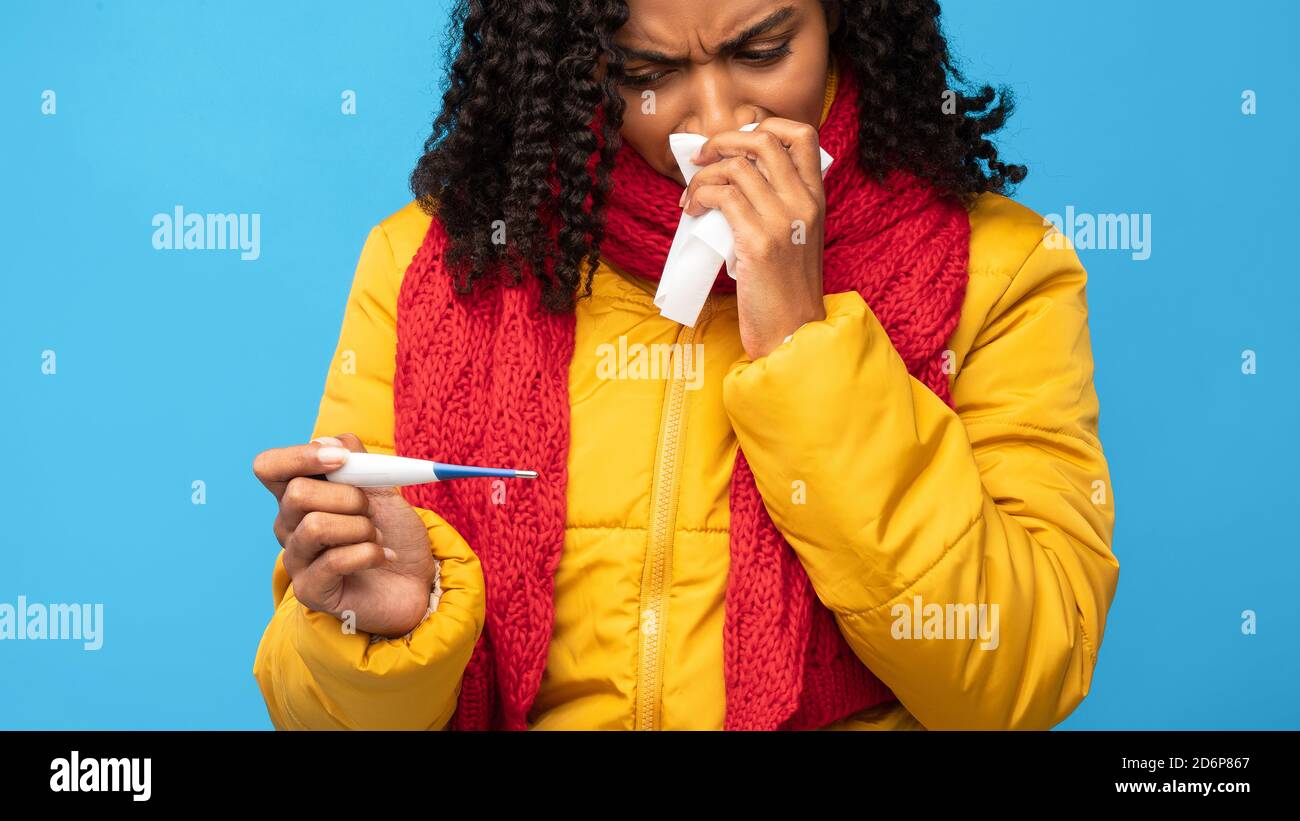 Woman Holding Thermometer Having Fever Sneezing In Tissue In Studio ...