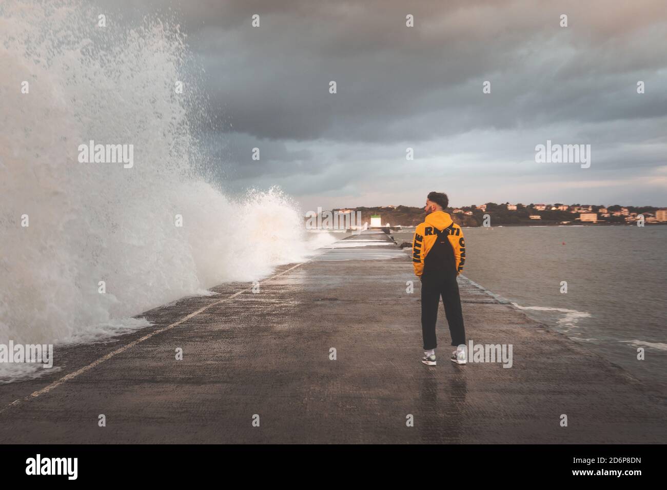 Young caucasian boy posing next to a brave sea Stock Photo - Alamy