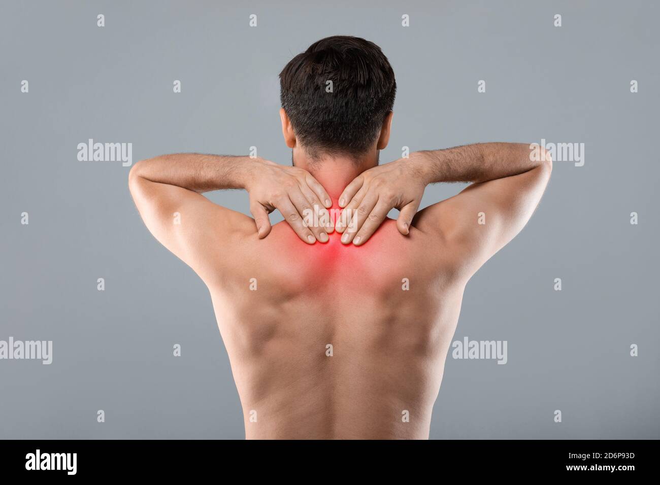 Strong man with neck pain, back view Stock Photo - Alamy