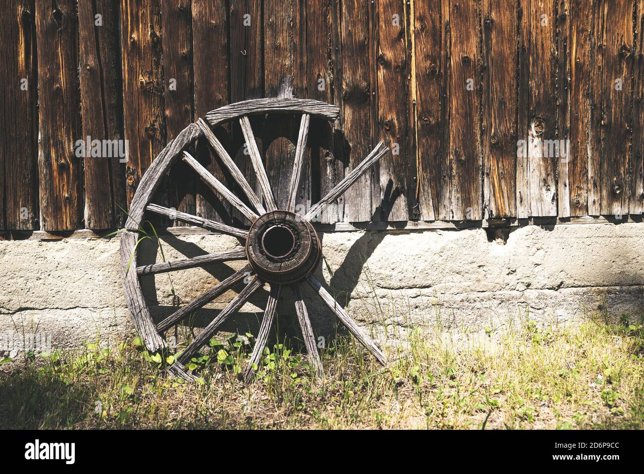 Rustic wagon wheel against an old log cabin. Taken in Bannack Ghost ...
