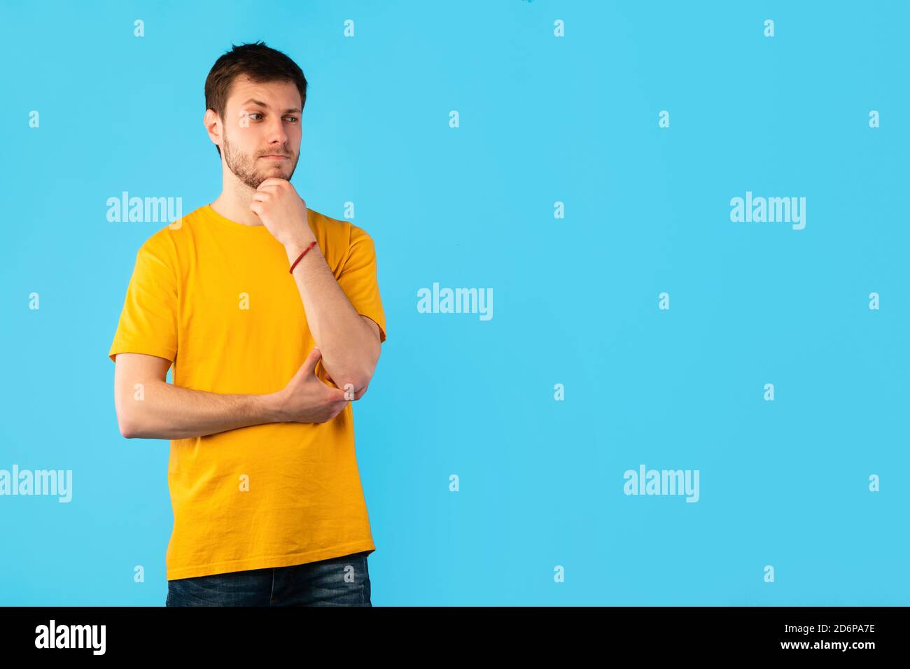 Pensive guy thinking about question, touching chin Stock Photo - Alamy