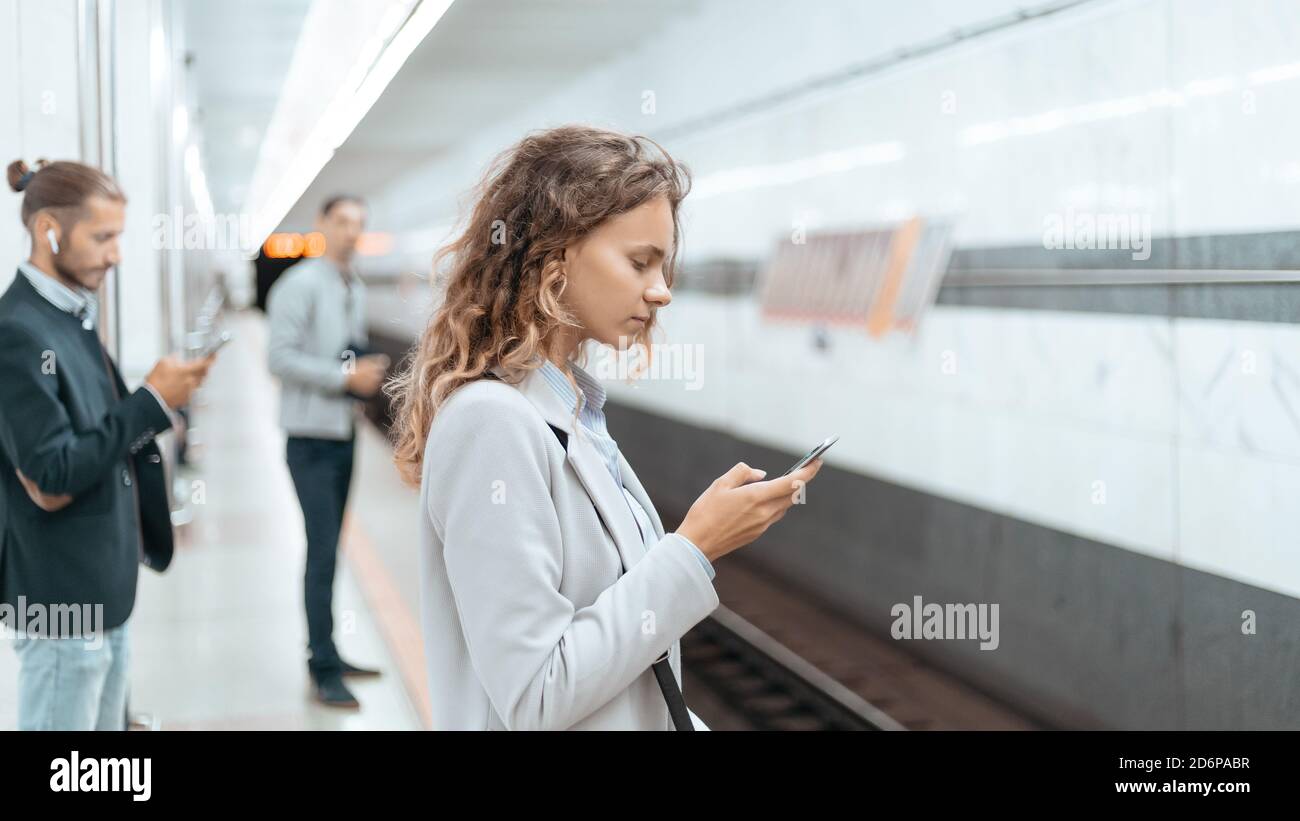 passengers wait for the train standing on the subway platform Stock ...