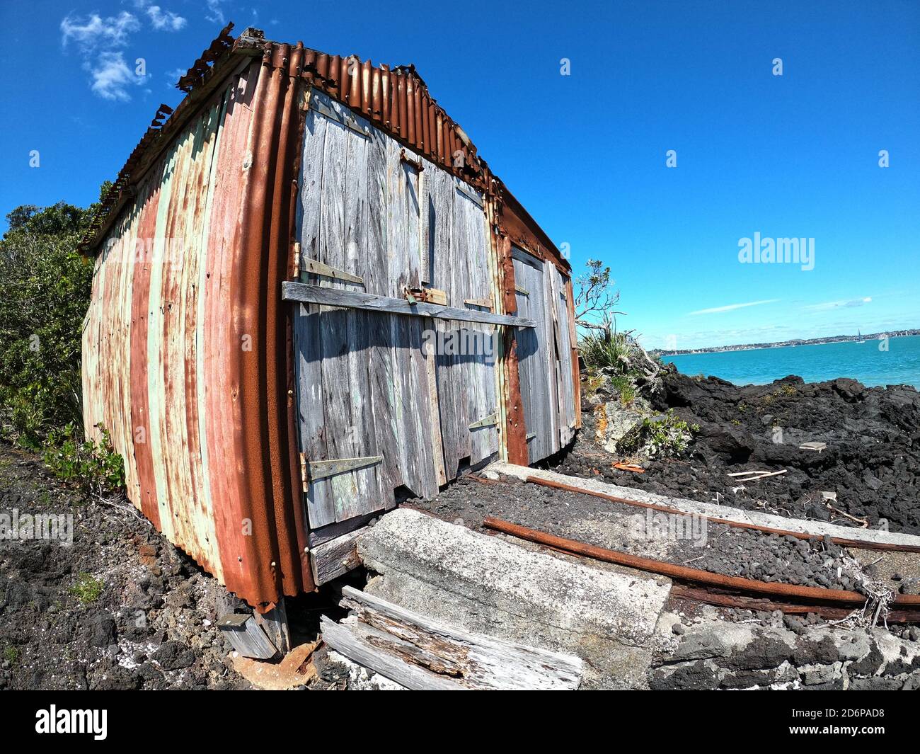 An abandoned, weathered shack with corrugated iron and wooden doors ...