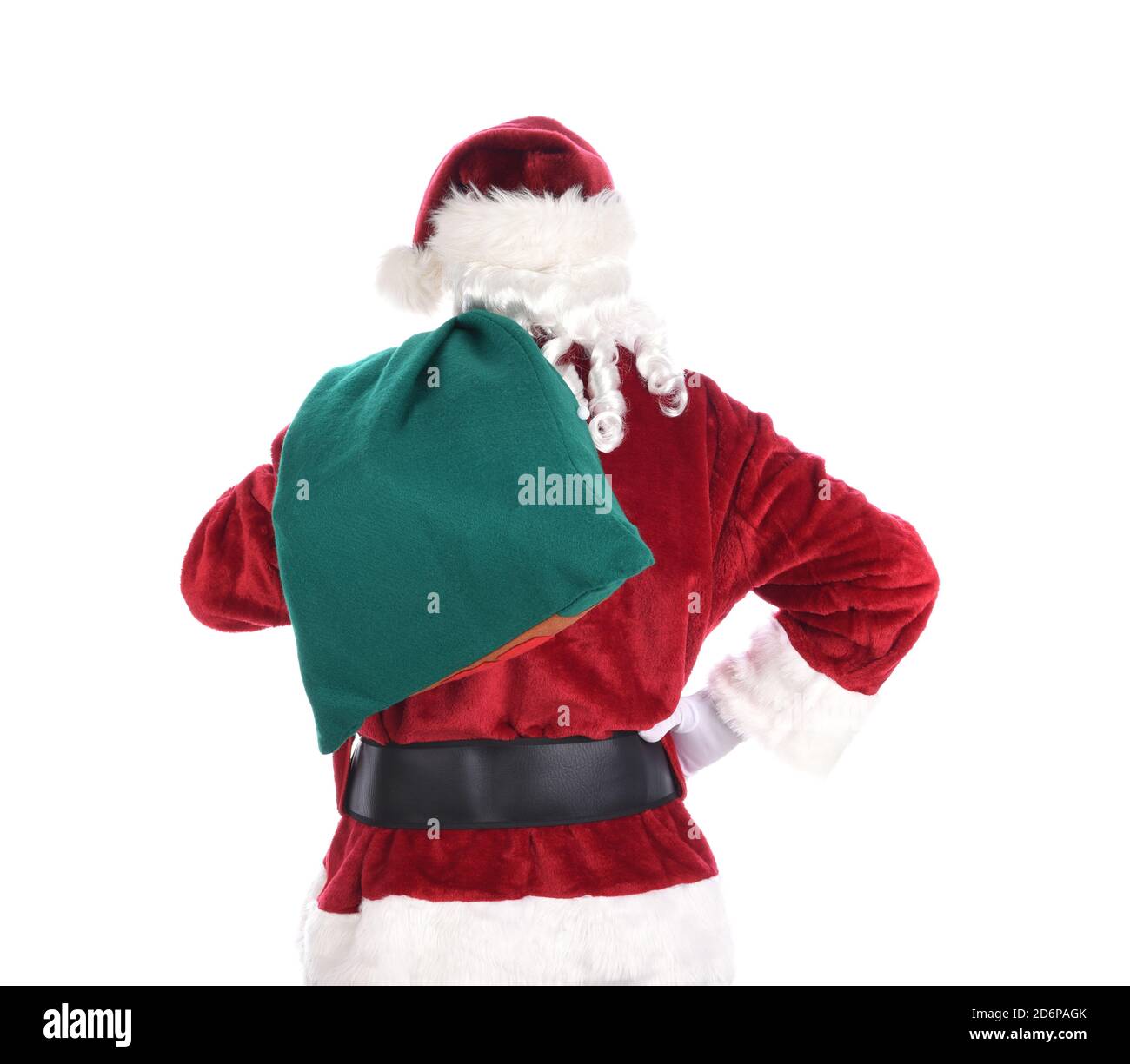 Santa Claus seen from behind with a hand on one hip and a bag of toys ...