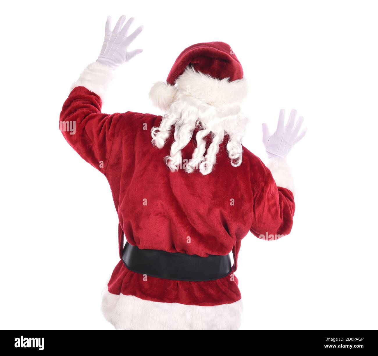 Santa Claus seen from behind with hands in the air in a startled or ...
