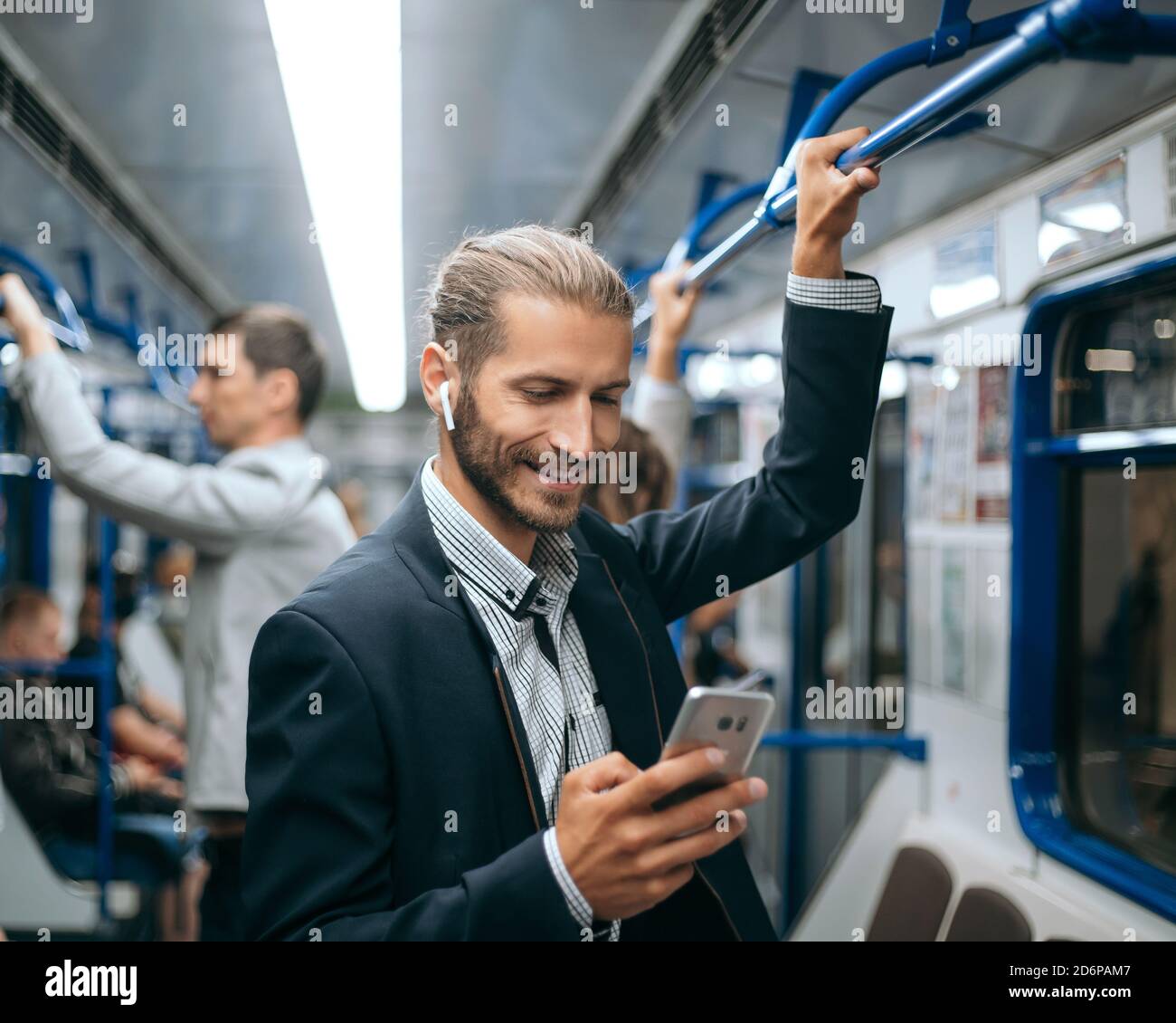 Man looking the mobile in metro hi-res stock photography and images - Alamy