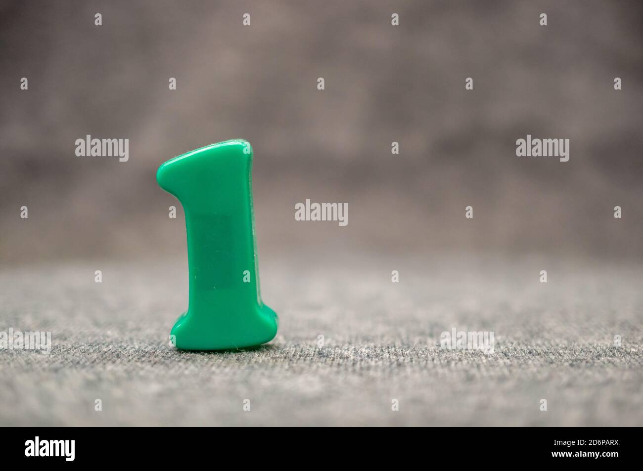 Closeup of a toy number "1" on gray background Stock Photo - Alamy