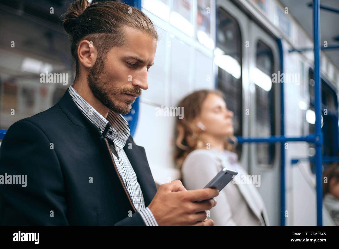 man using his smartphone while sitting in the train subway Stock Photo ...