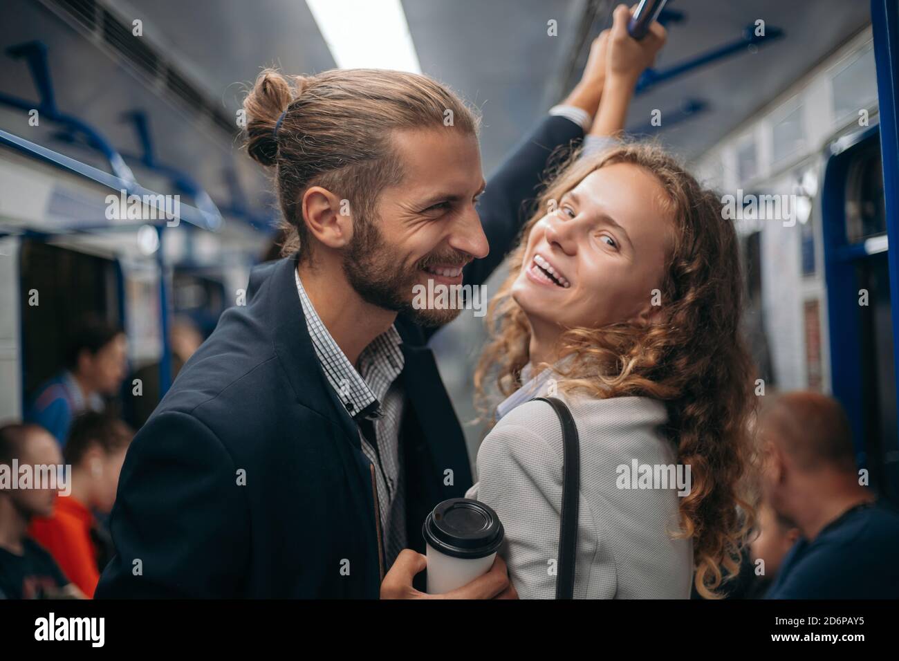 happy couple standing in a subway train Stock Photo - Alamy
