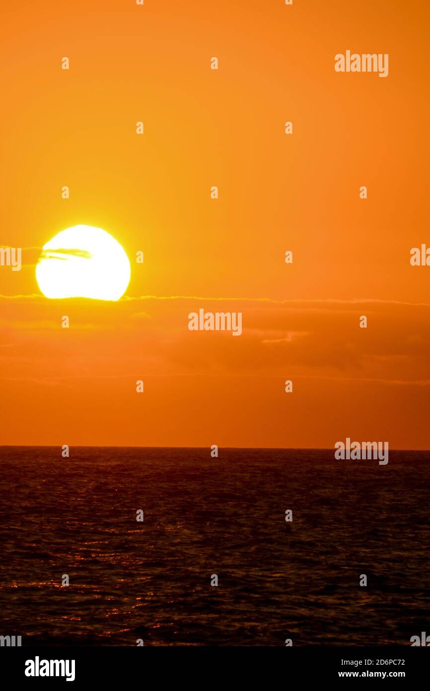 The Sun Setting in the Sea Stock Photo - Alamy
