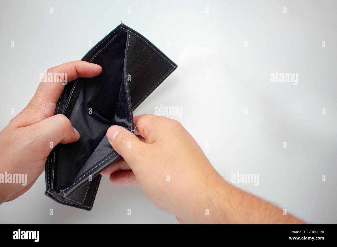 A person opening an empty wallet on a white background. Concept: No ...