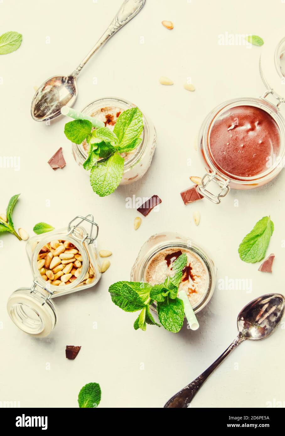 Chocolate-mint milkshake with pine nuts, gray background, top view ...