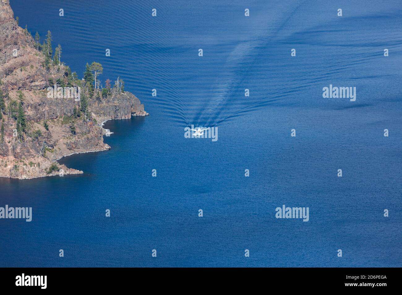 A tour boat takes people around the the magnificently blue and deep ...