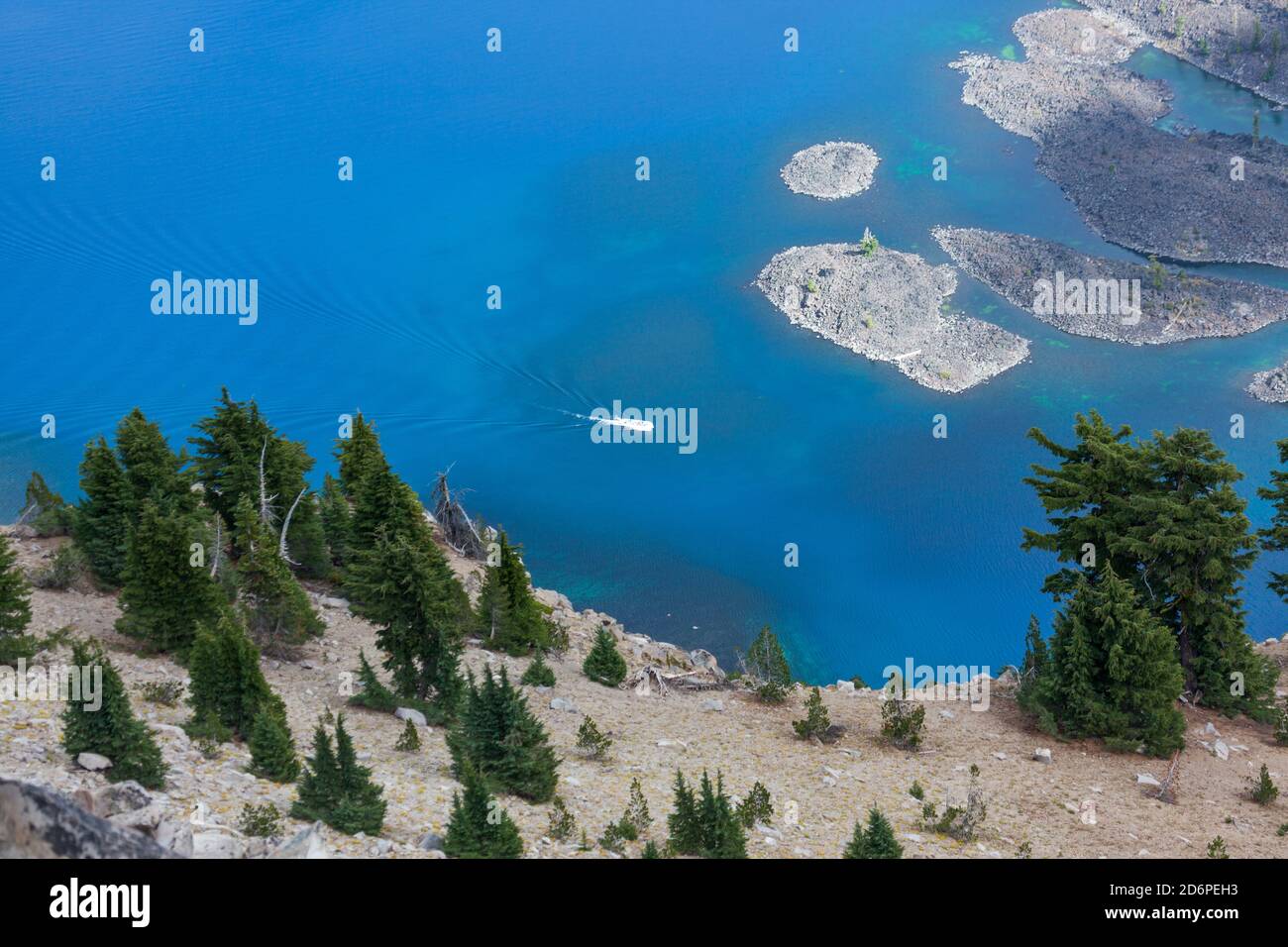 A tour boat takes people around the the magnificently blue and deep ...