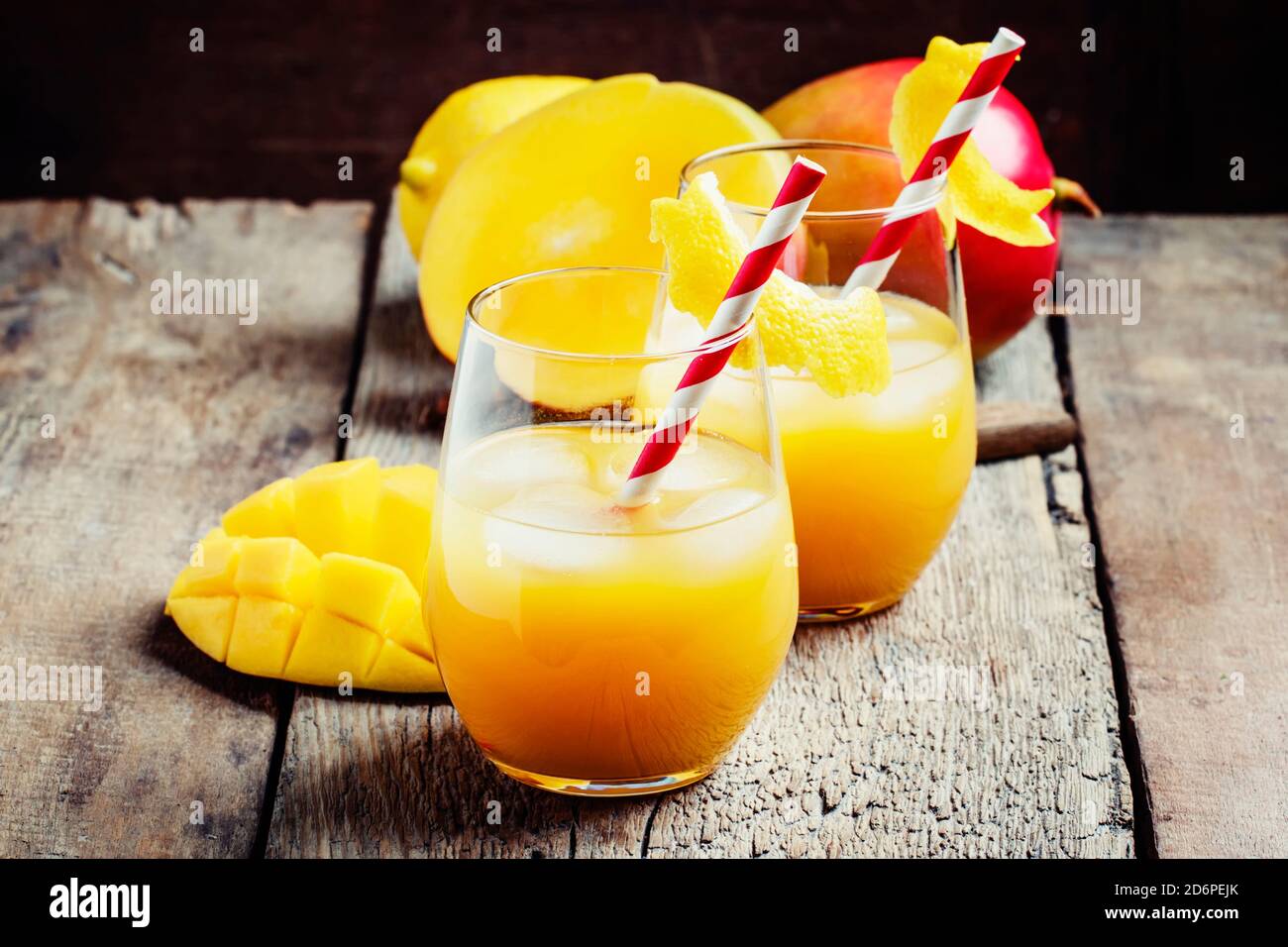 Freshly squeezed mango juice with ice and straws. Vintage wooden ...