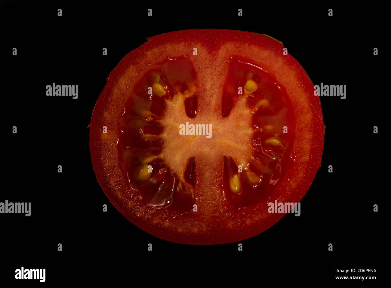 fresh half sliced tomato on black background Stock Photo - Alamy