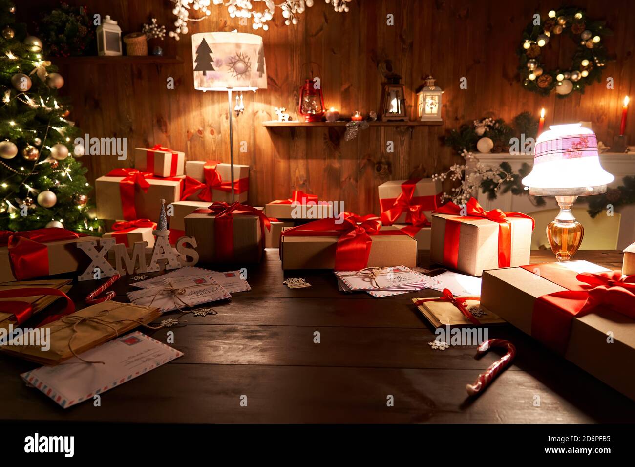 Santa workshop table with Merry Christmas tree, gift boxes pile on xmas ...