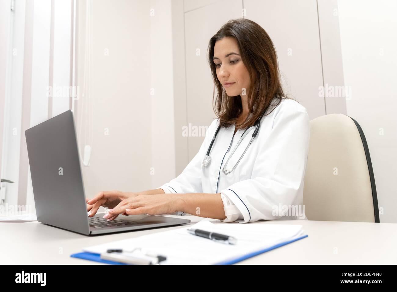 Doctor explaining with patient via laptop computer, mobile health ...