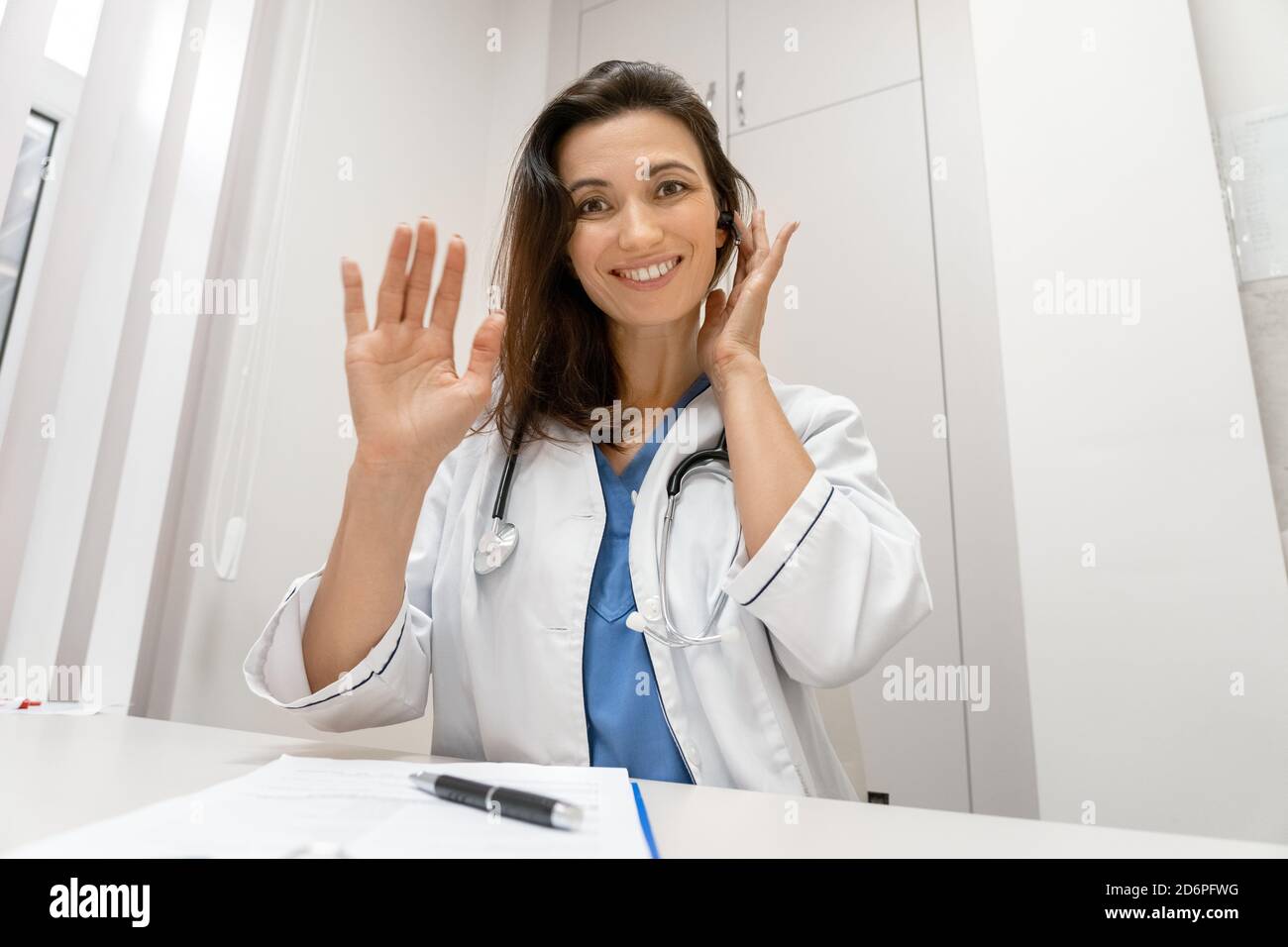 Horizontal portrait of smiling young female doctor looking at the ...