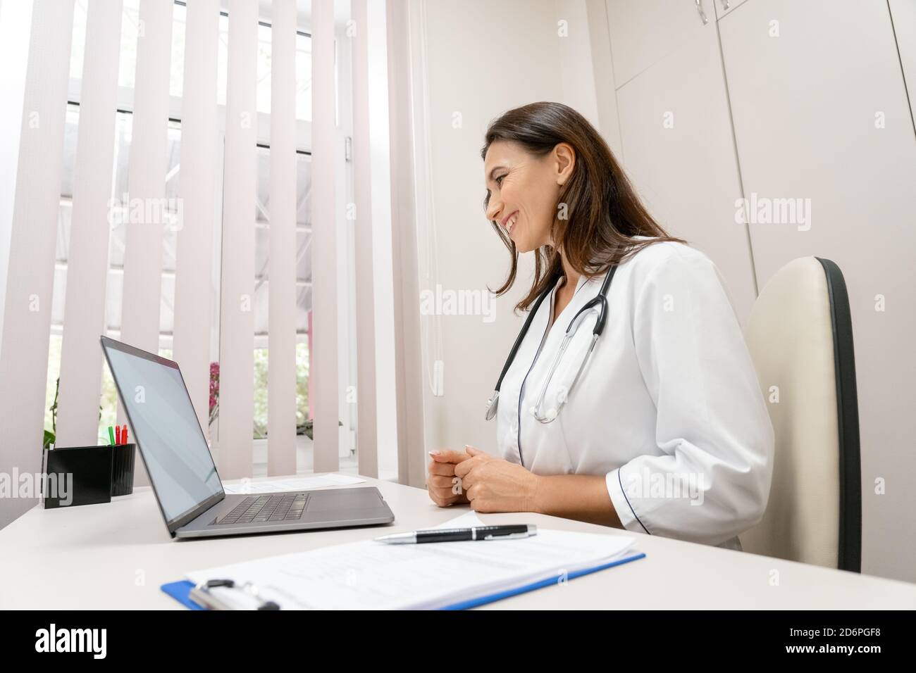 Female doctor wear white medical robe make online video call consult ...