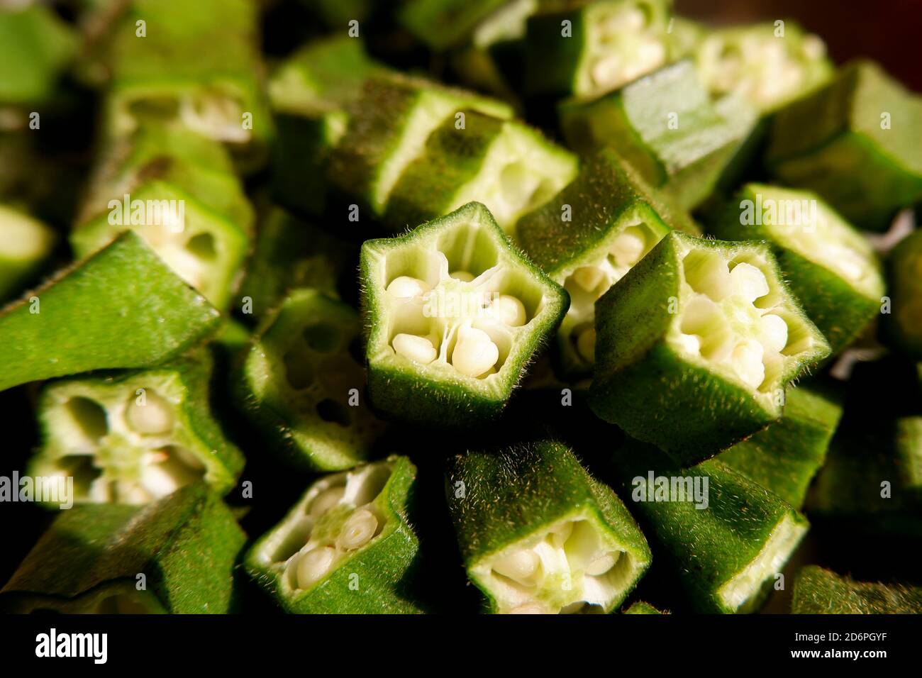 a top shot of fresh lady fingers cut pieces isolated on plate Stock ...