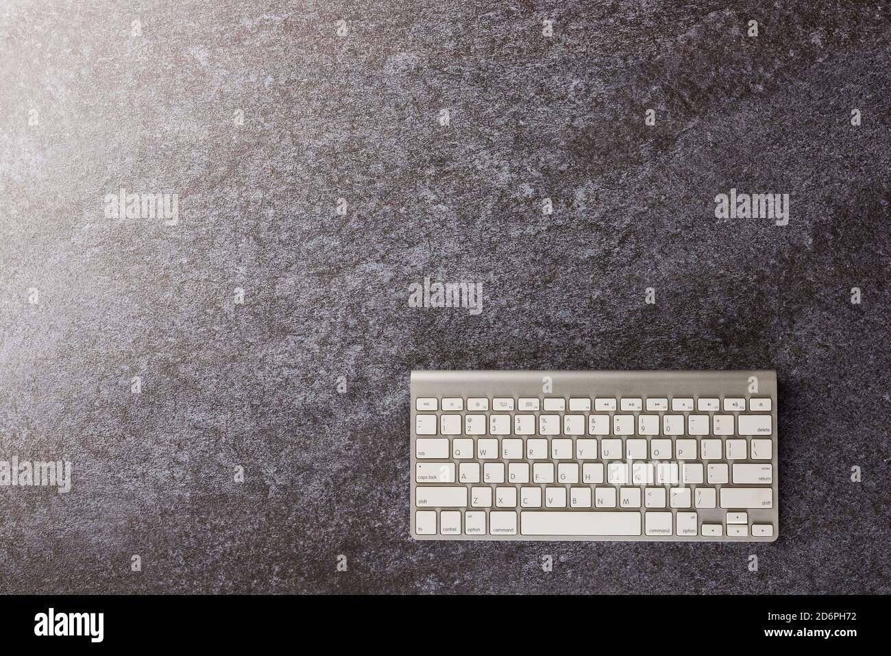 Top view flat lay of a modern white computer keyboard on office desk ...
