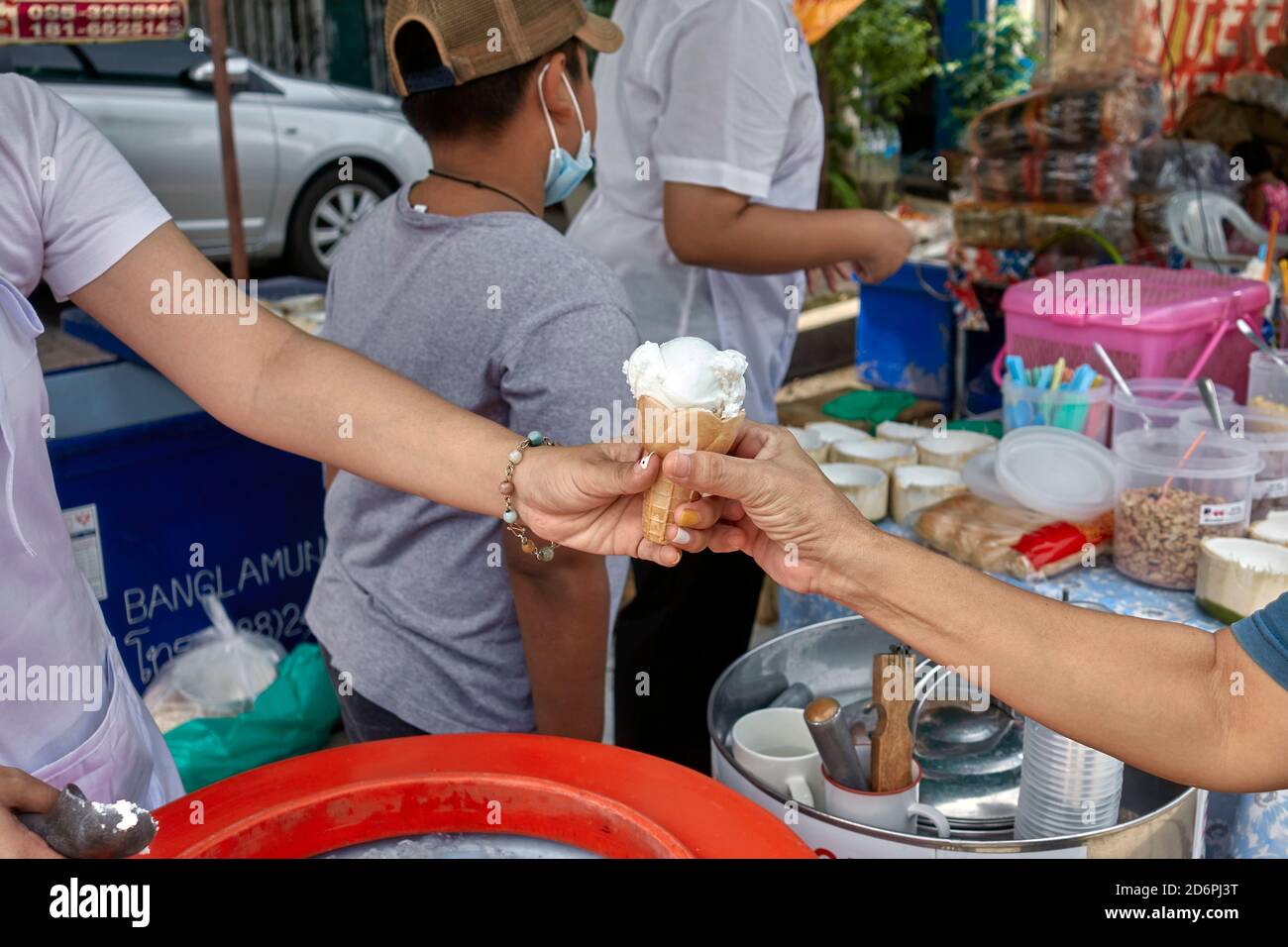 Ice cream stall with customers being served by staff. Thailand street ...