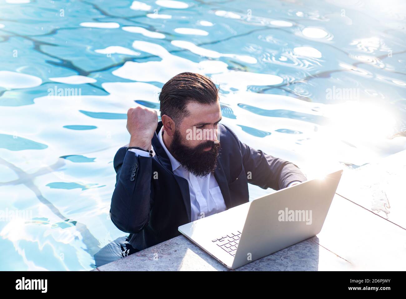 Using computer in swimming pool hi-res stock photography and images - Alamy