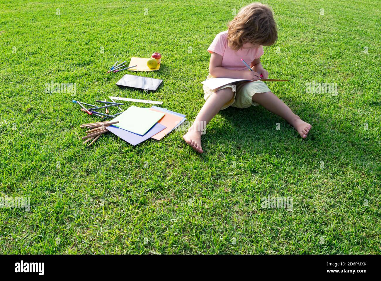 Kid in park reading for education. Home outside learning Stock Photo ...