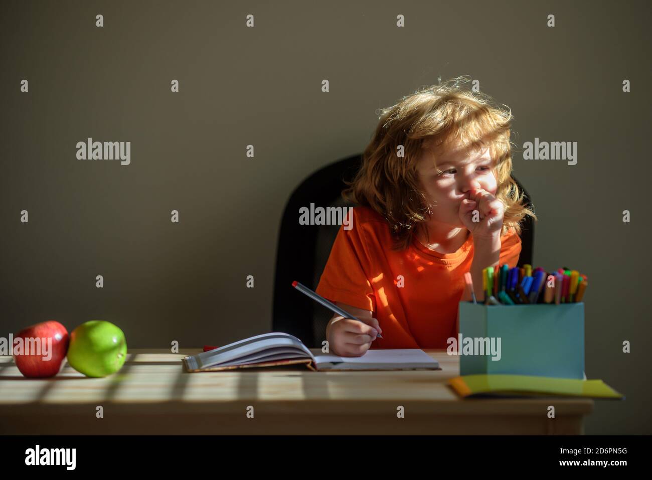 Little school kid boy doing homework at home. Child thinking, kids ...