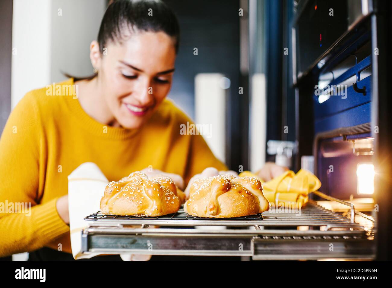 mexican woman cooking Pan de Muerto traditional bread for day of the ...