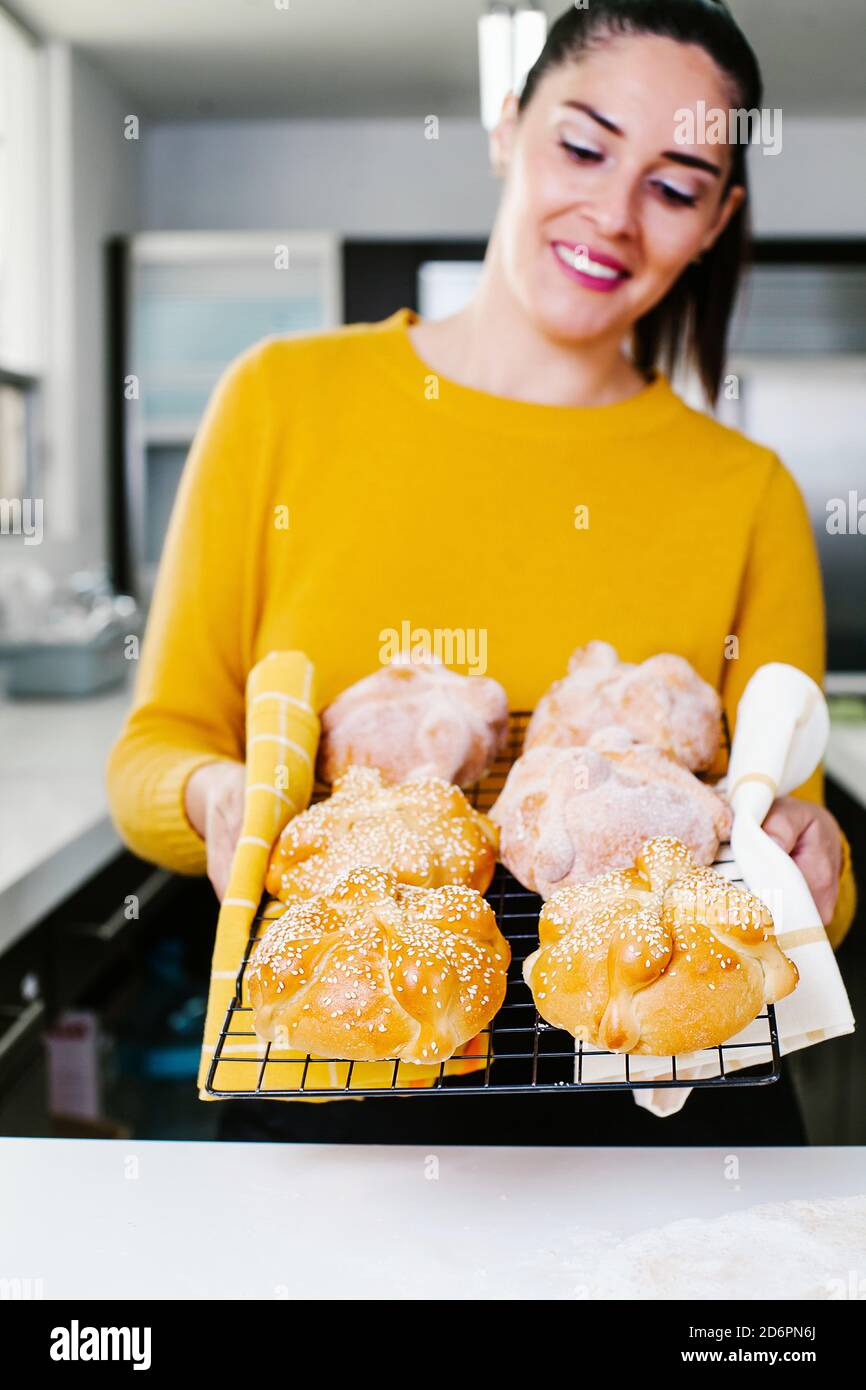 mexican woman cooking Pan de Muerto traditional bread for day of the ...