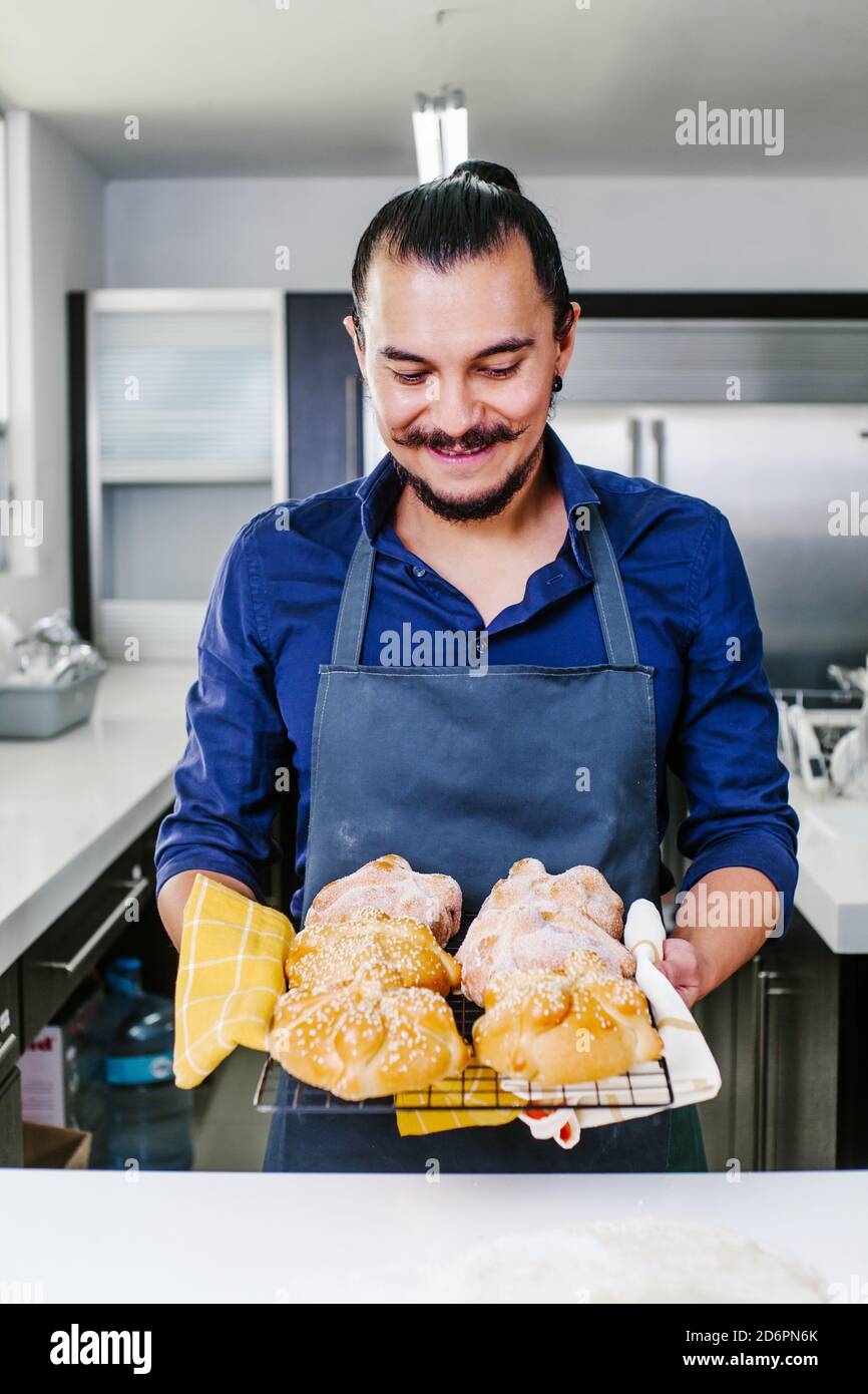 Mexican man cooking Pan de Muerto Traditional bread for day of the dead ...