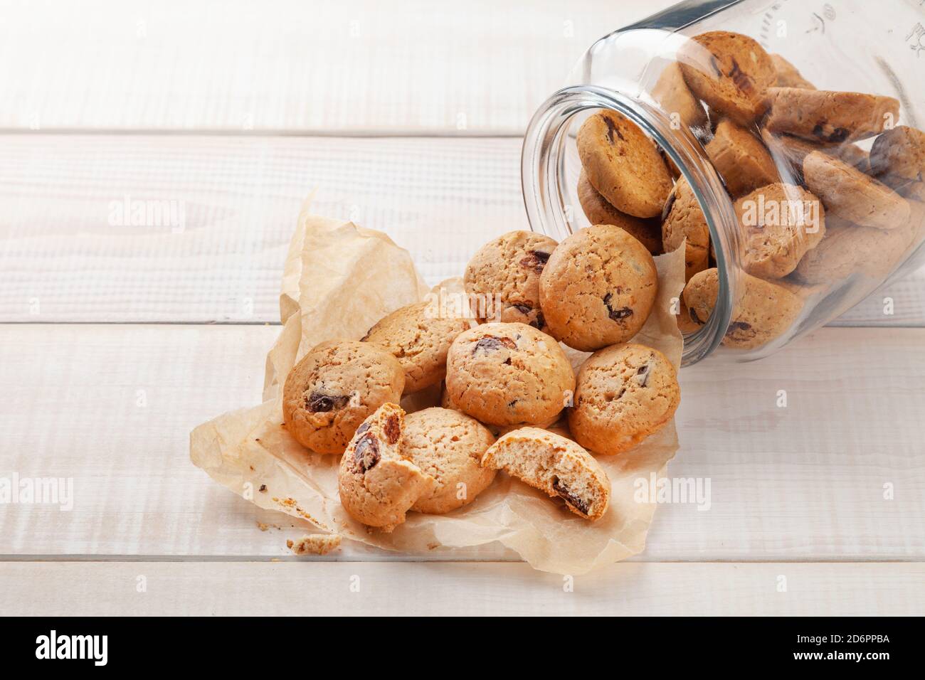 Sweet round cookies with berry, scattered from transparent glass bank ...