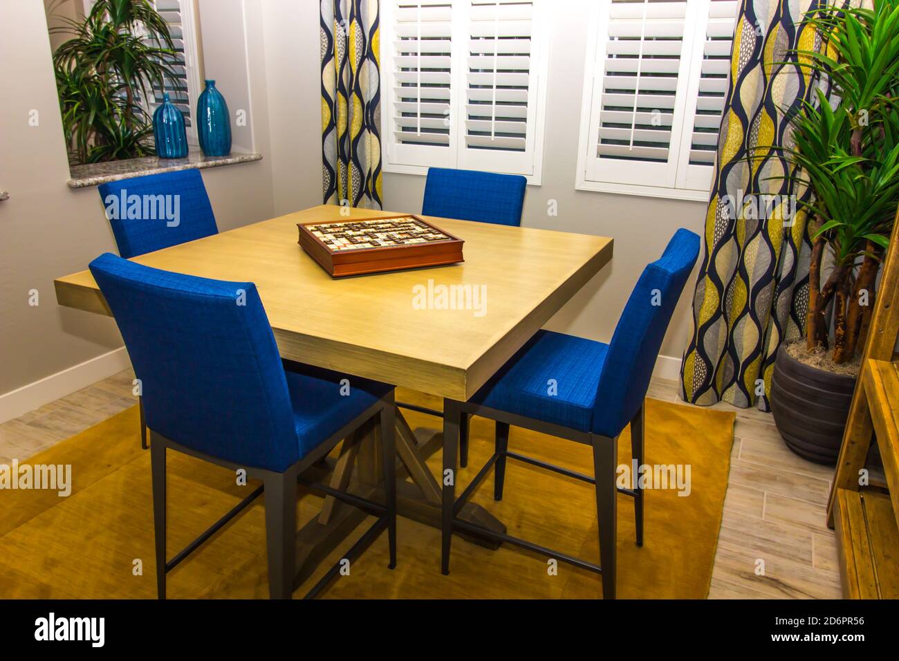 Wooden Game Table With Bright Blue Chairs Stock Photo - Alamy