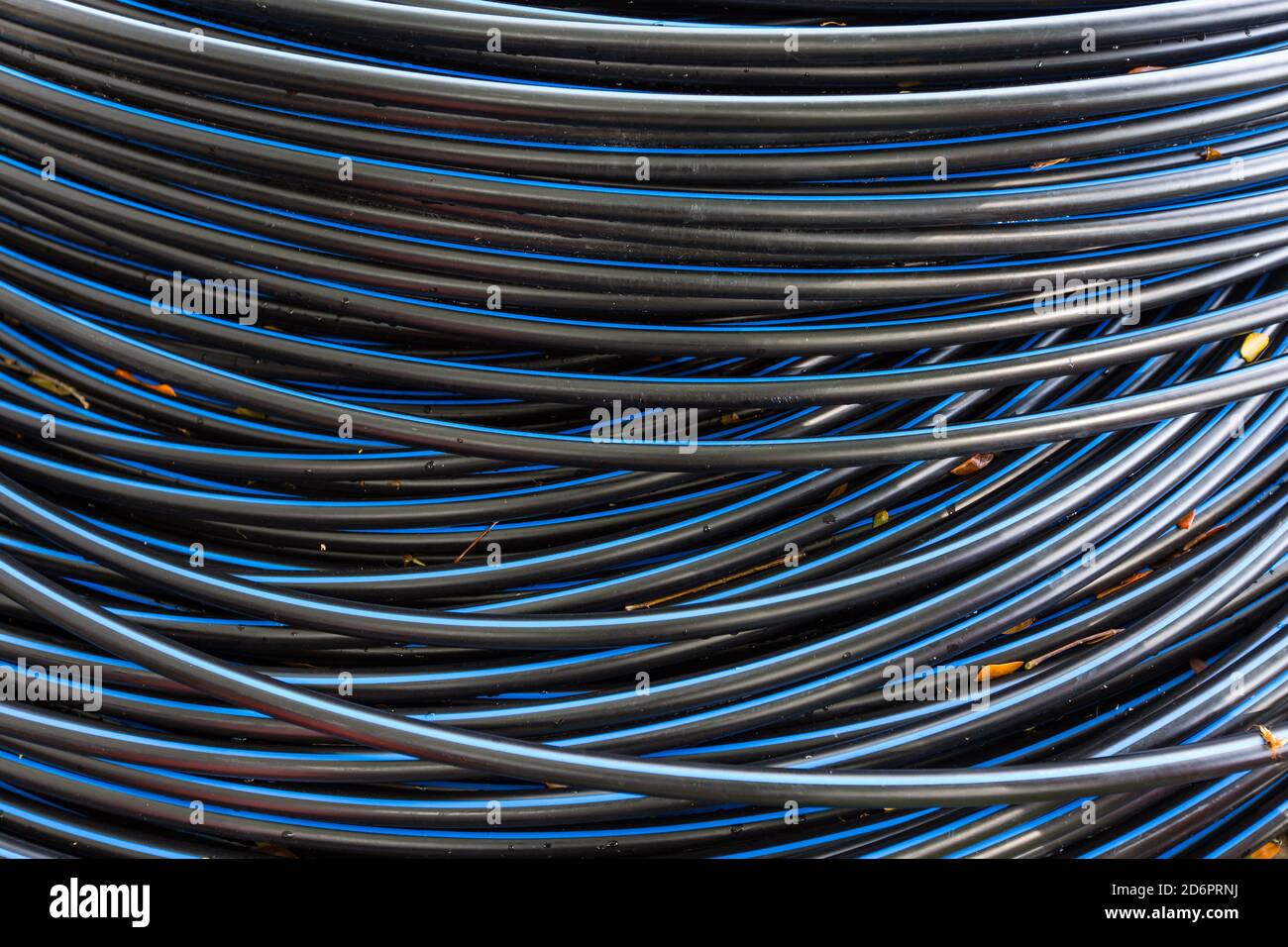 Close up of fiber optics black color cable in coil up position, used ...