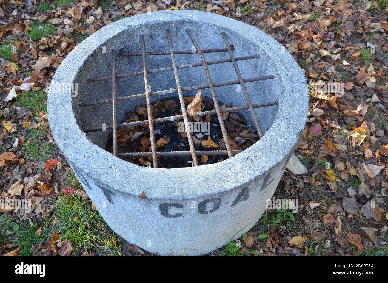 cement hot coal container or bin with metal bars and leaves Stock Photo ...