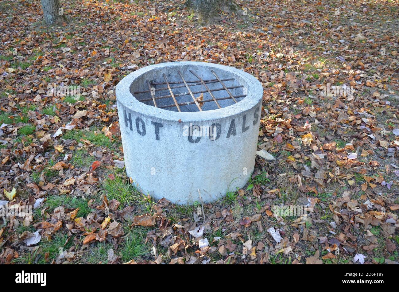 cement hot coal container or bin with metal bars and leaves Stock Photo ...