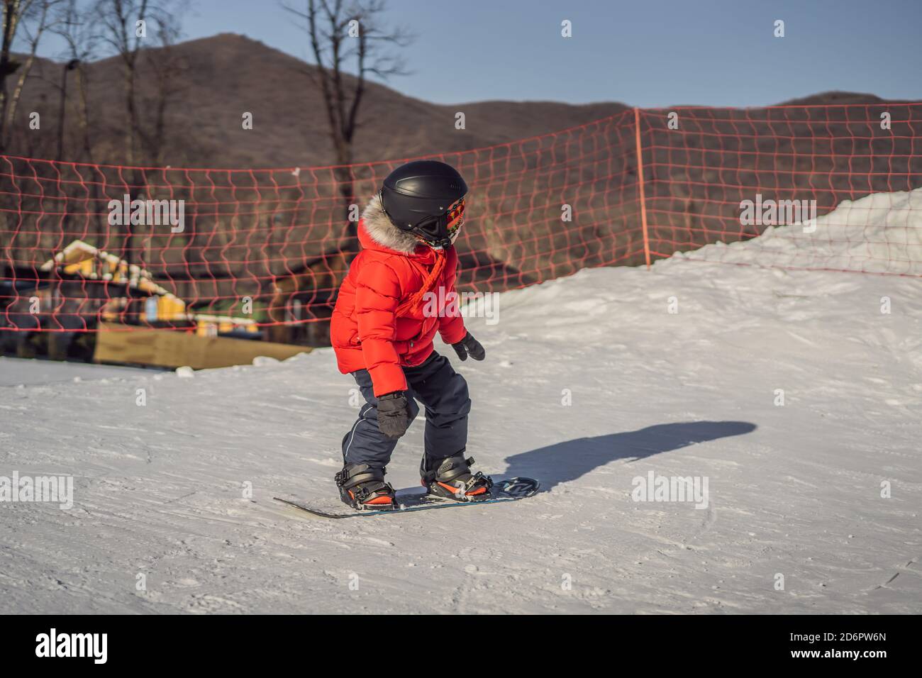 Little cute boy snowboarding. Activities for children in winter ...