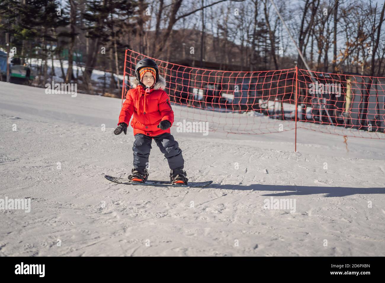 Little cute boy snowboarding. Activities for children in winter ...