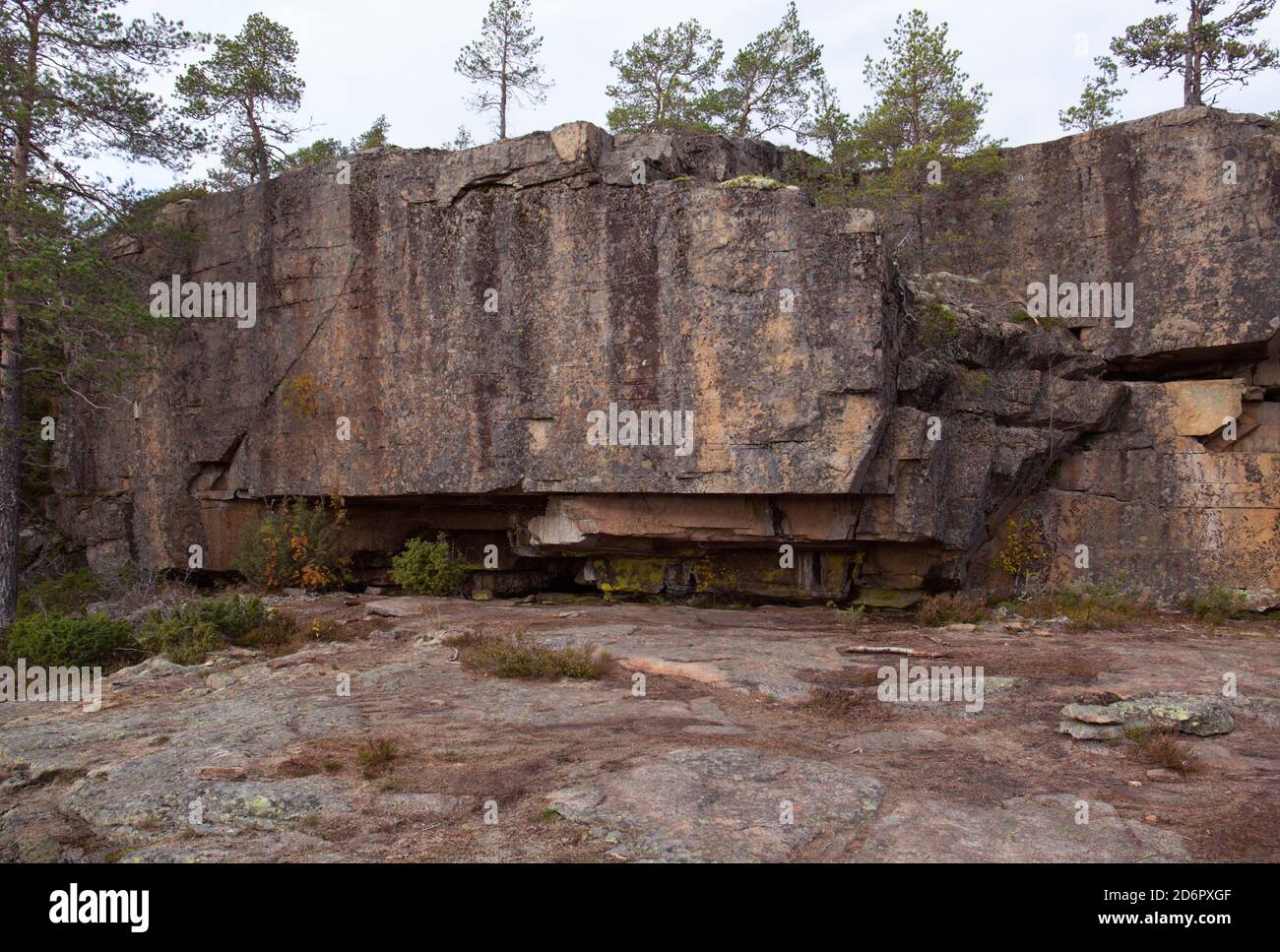 View of a cave among amazing rock formations. Huge block on a rocky ...